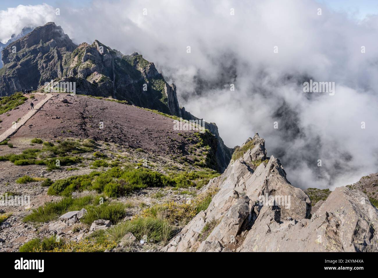 landscape with sharp volcanic cliff and barren slope standing out of ...