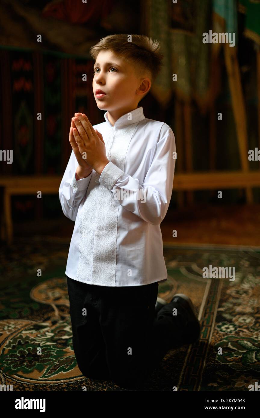 Child Kneeling In Prayer