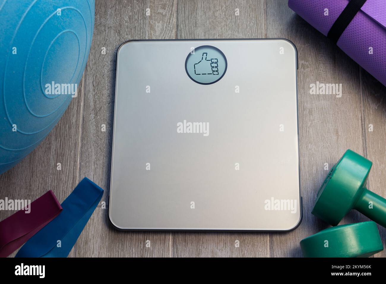 background Top view of a scale surrounded by a pilates ball, elastic ...