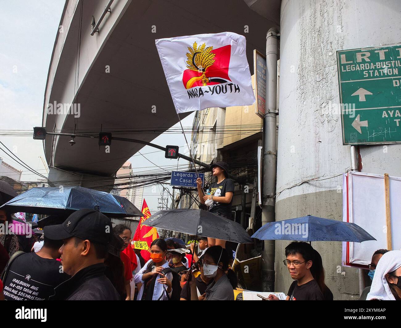 A protester from the NNARA-YOUTH group waves their flag on Bonifacio ...