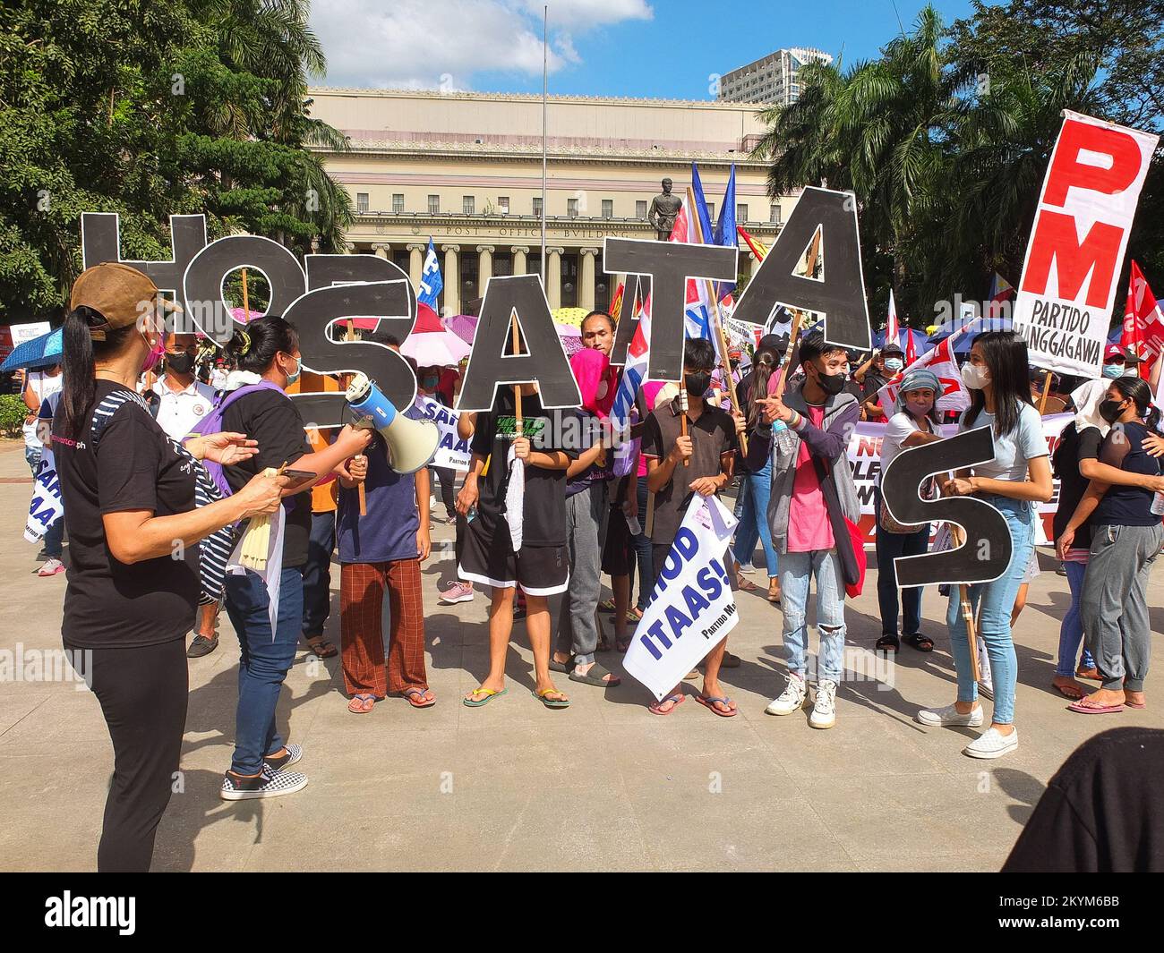 Protesters positioning themselves while holding signs on Bonifacio Day ...