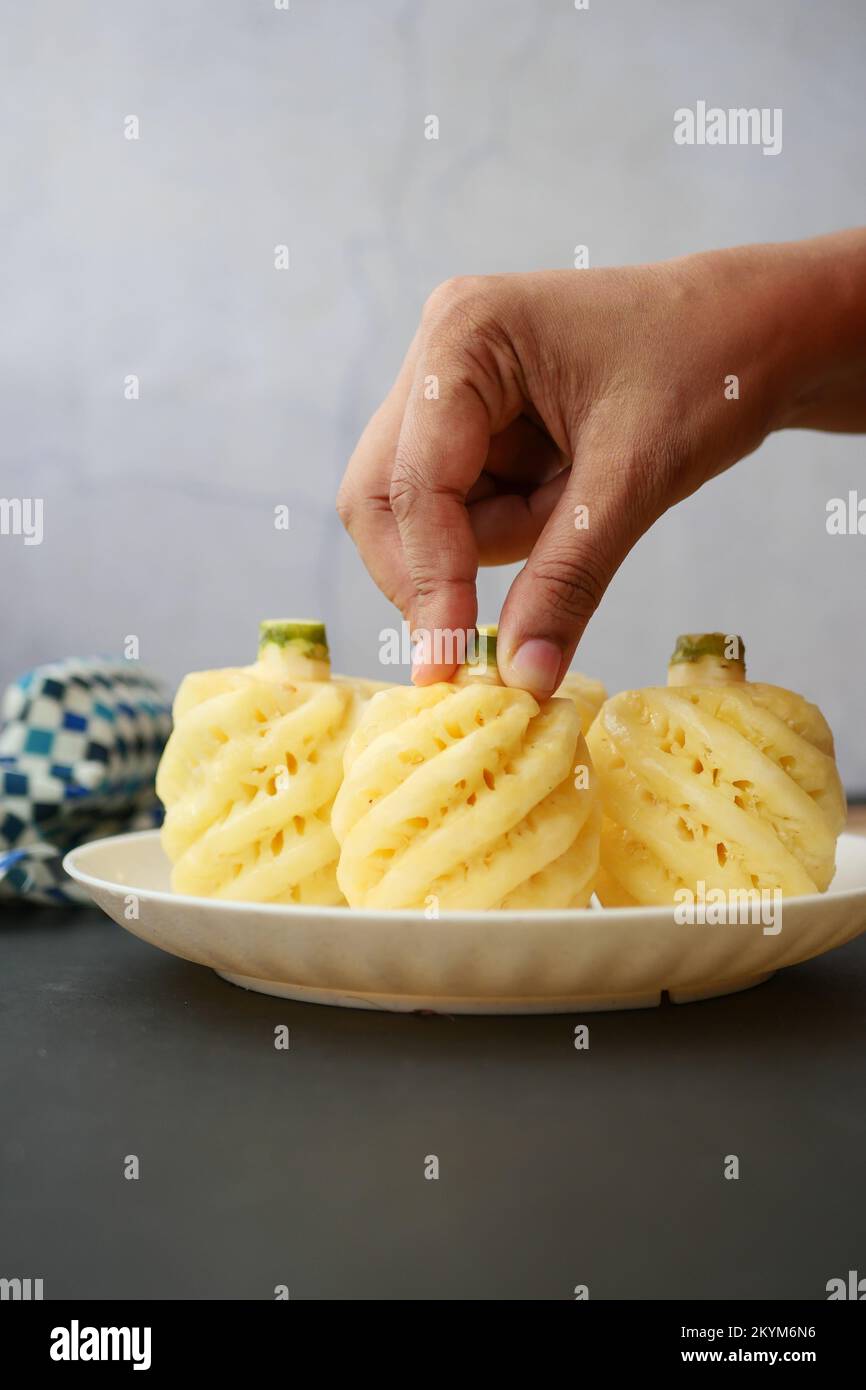 Hand pick slice pineapple hi-res stock photography and images - Alamy