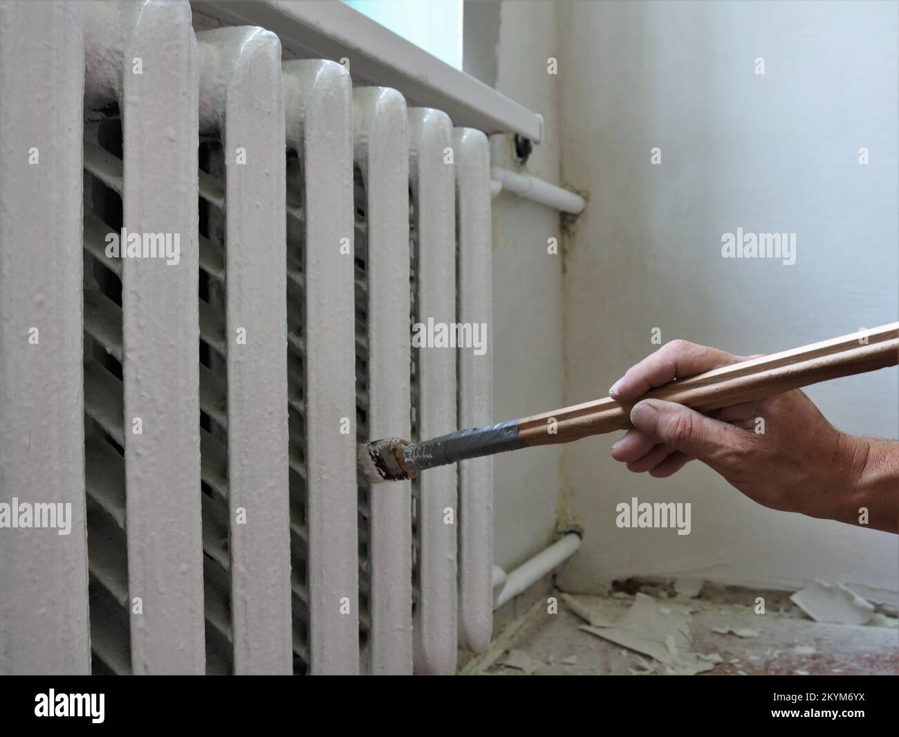 updating the color of apartment iron radiators during repairs with a ...