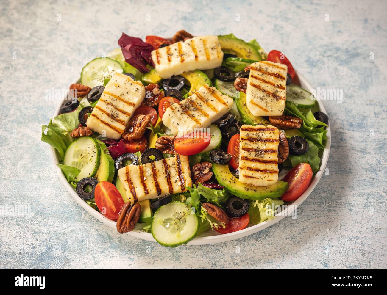 Greek style cuisine - salad with grilled halloumi cheese, avocado ...