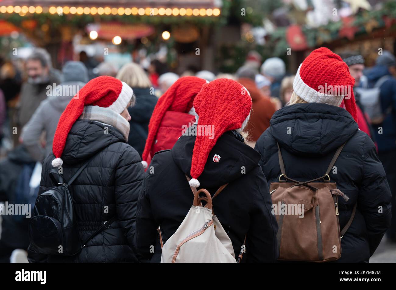 Dresden, Germany. 01st Dec, 2022. Visitors wearing Santa Claus hats ...
