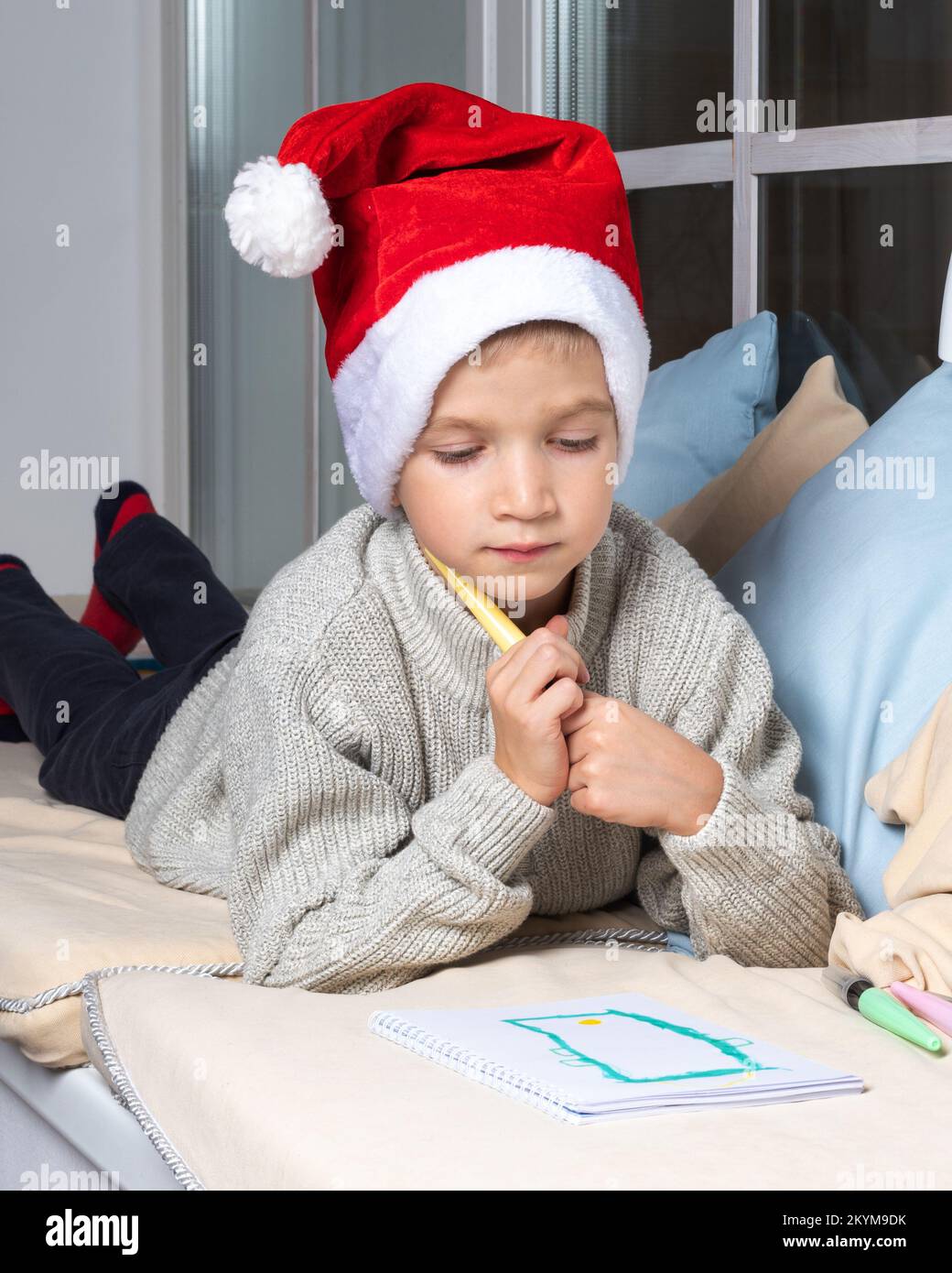 A wish list for a Christmas miracle. A serious focused kid in a Santa ...