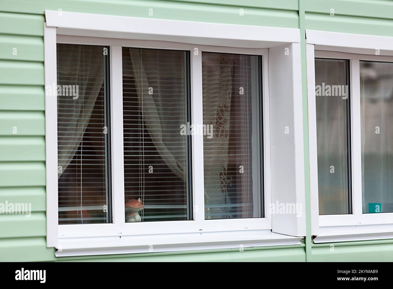 White window openings of plastic windows with an external facade of ...