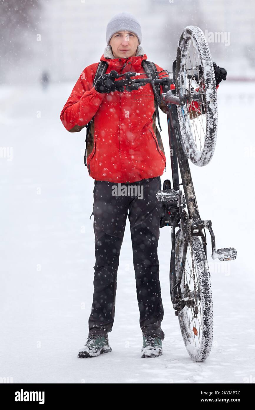 A man lifted a bicycle behind the wheel on the rear wheel, a winter ...