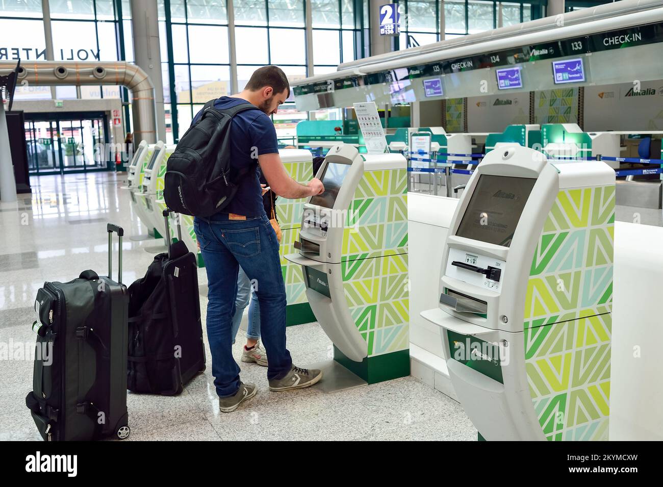 ROME, ITALY - AUGUST 16, 2015: man use self check-in kiosks in ...