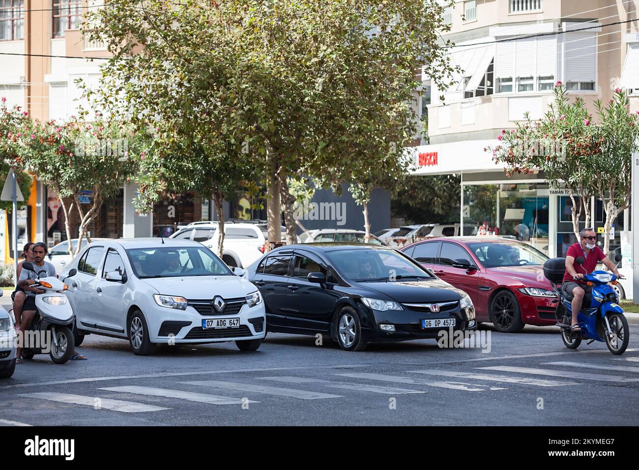 Alanya, Turkey-circa Oct, 2020: Passenger cars and mopeds stand in ...