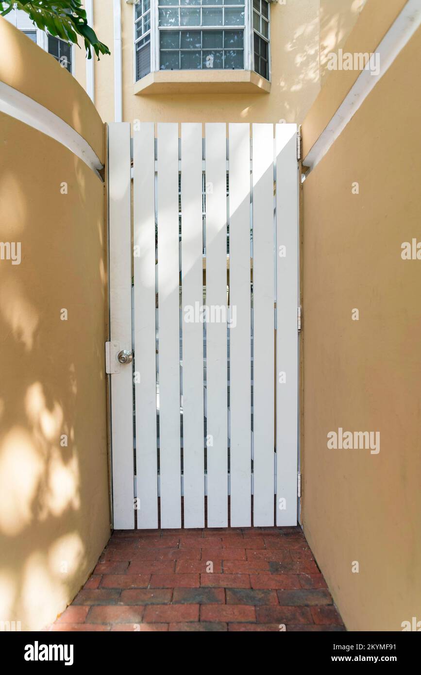 White door gate in the middle of building walls at Miami, Florida ...