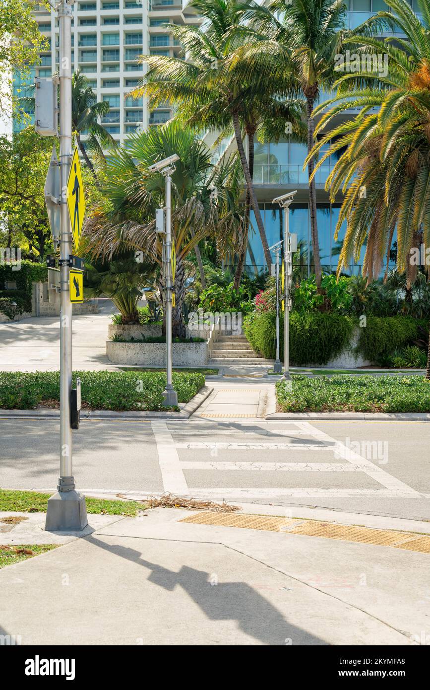 Crosswalk with yellow signs on the post at the side in Miami, Florida ...