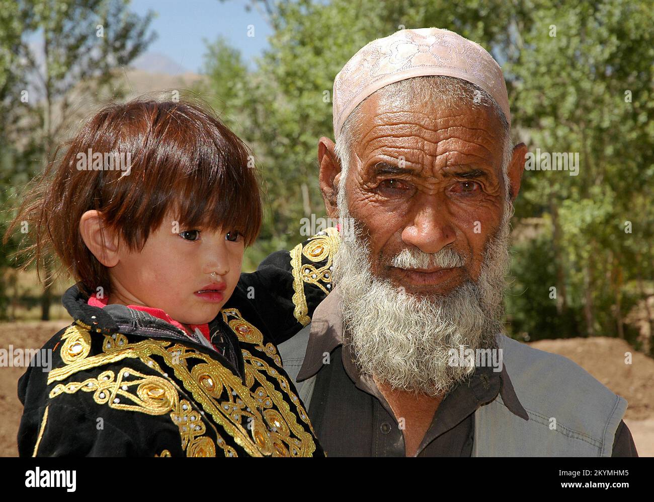 Bamyan (Bamiyan) / Central Afghanistan: An old Afghan man with a young ...