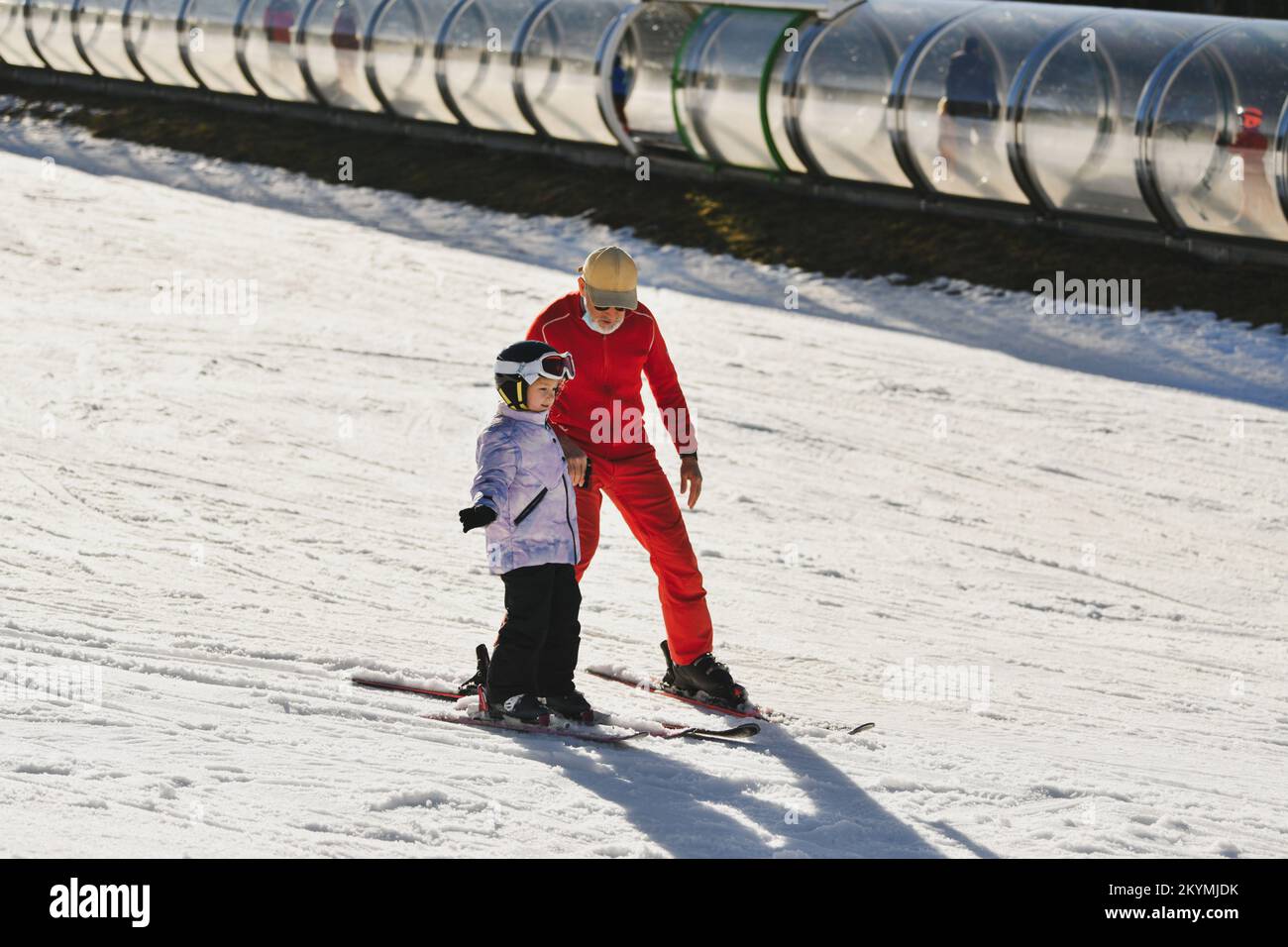 Ski coach giving a lesson to a child Stock Photo - Alamy