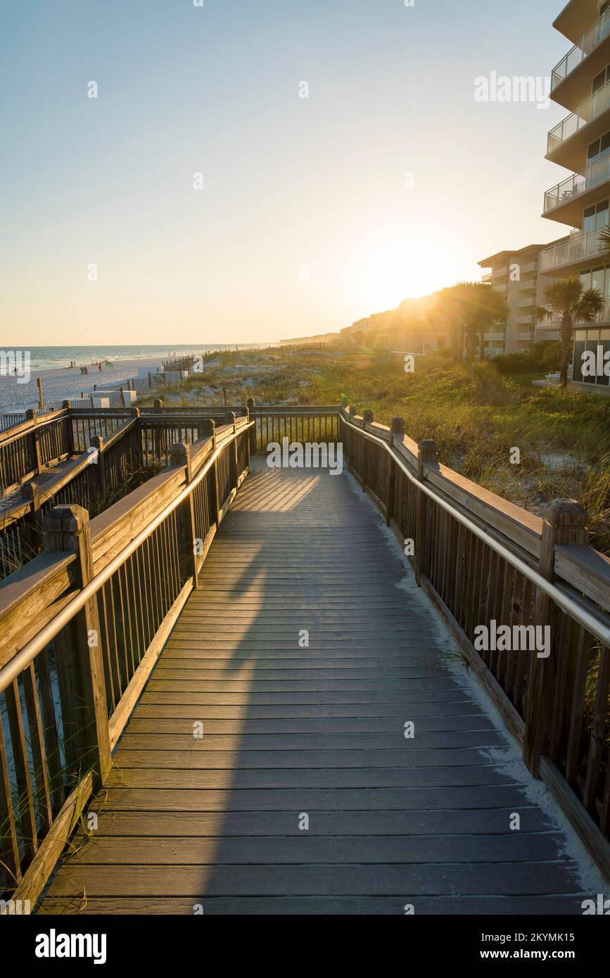 Sloped wooden boardwalk during sunset at the beach in Destin, Florida ...