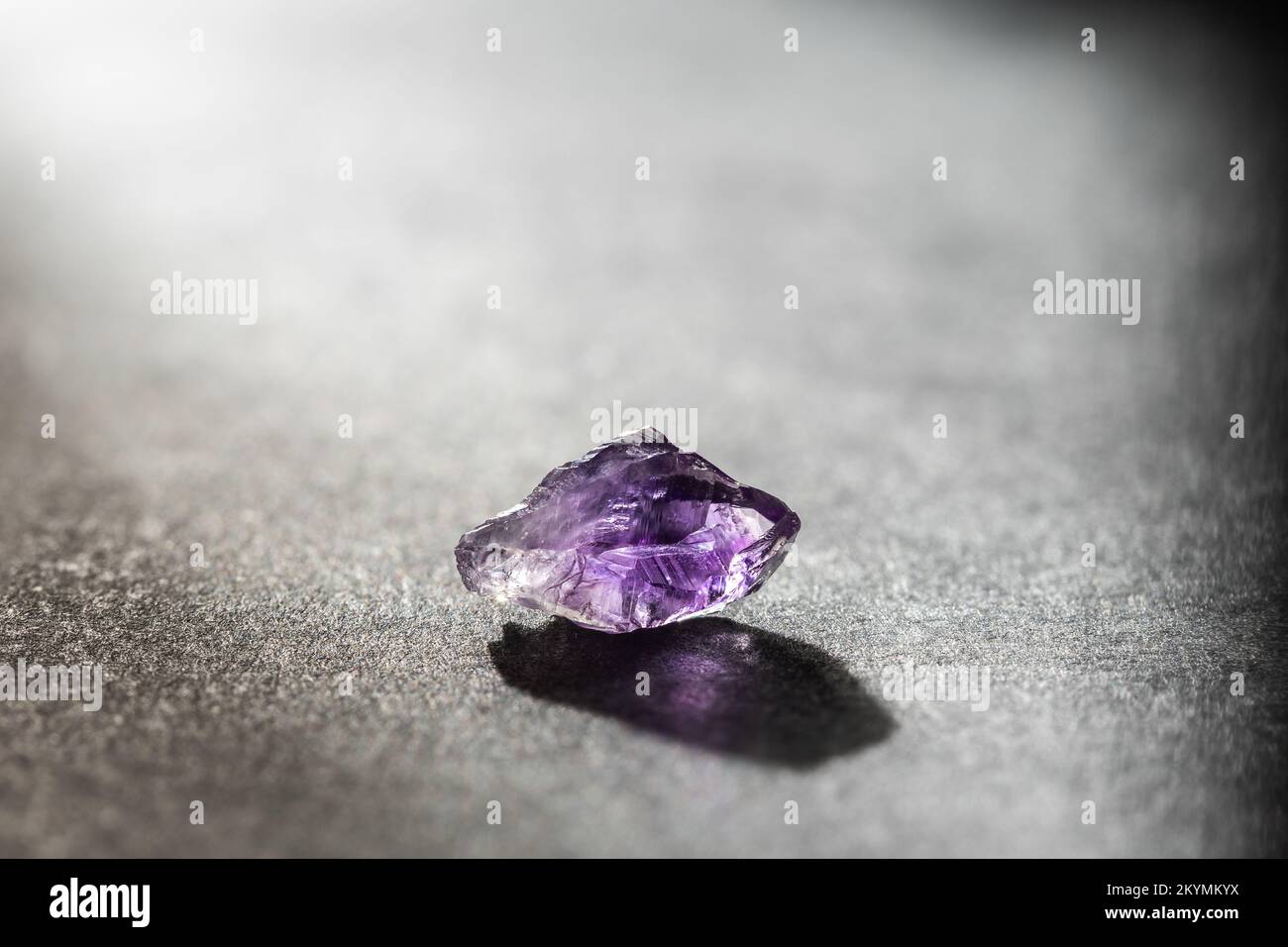 One Little Crystal of Purple Amethyst Mineral Stone Back Lit over Dark ...