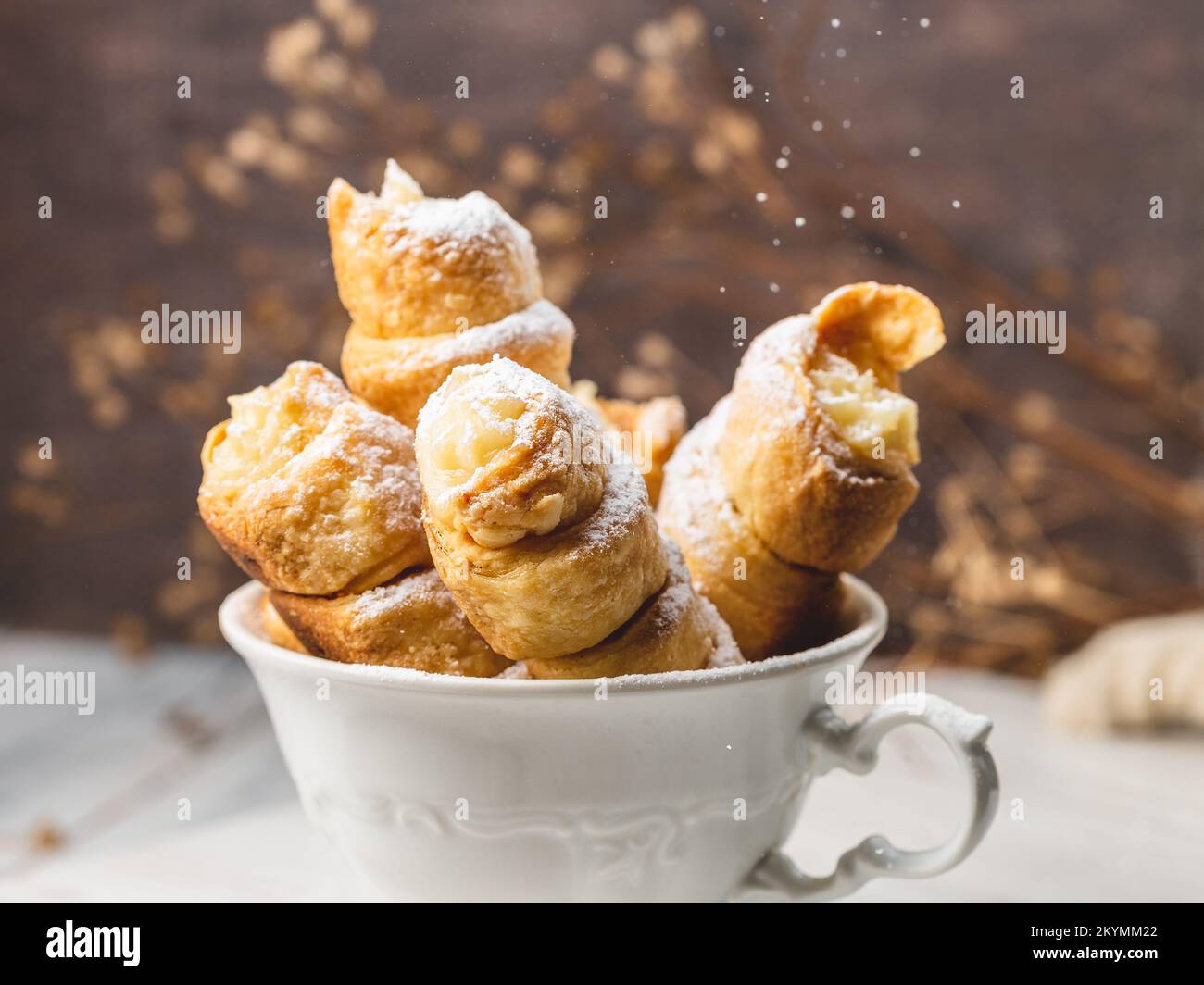 Homemade Pastry Tubes with Whipping Cream in the White Tea Cup over ...