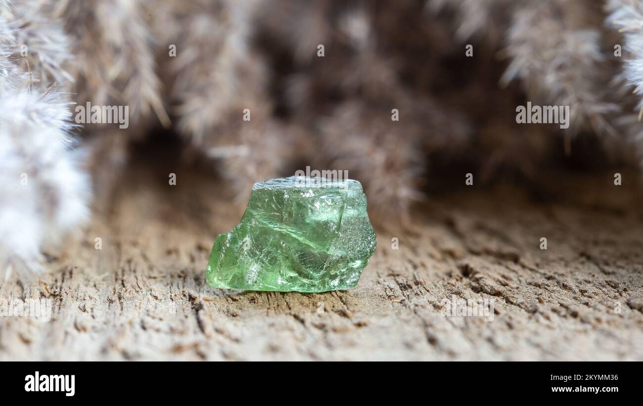 Translucent Green Apatite Crystal Healing Stone on Wooden Background ...