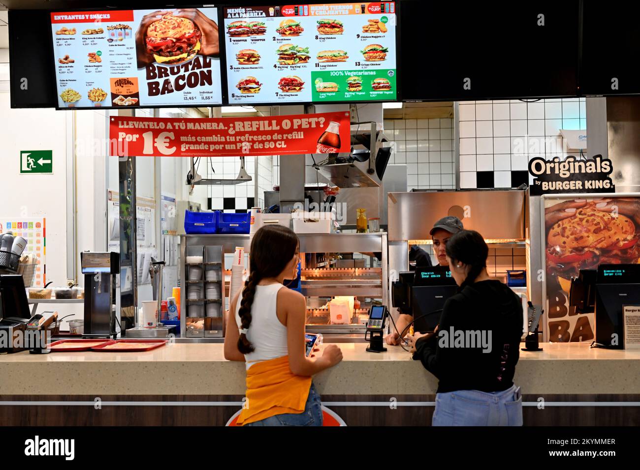 Burger King waitress serving two young women at counter, Gran Canaria ...