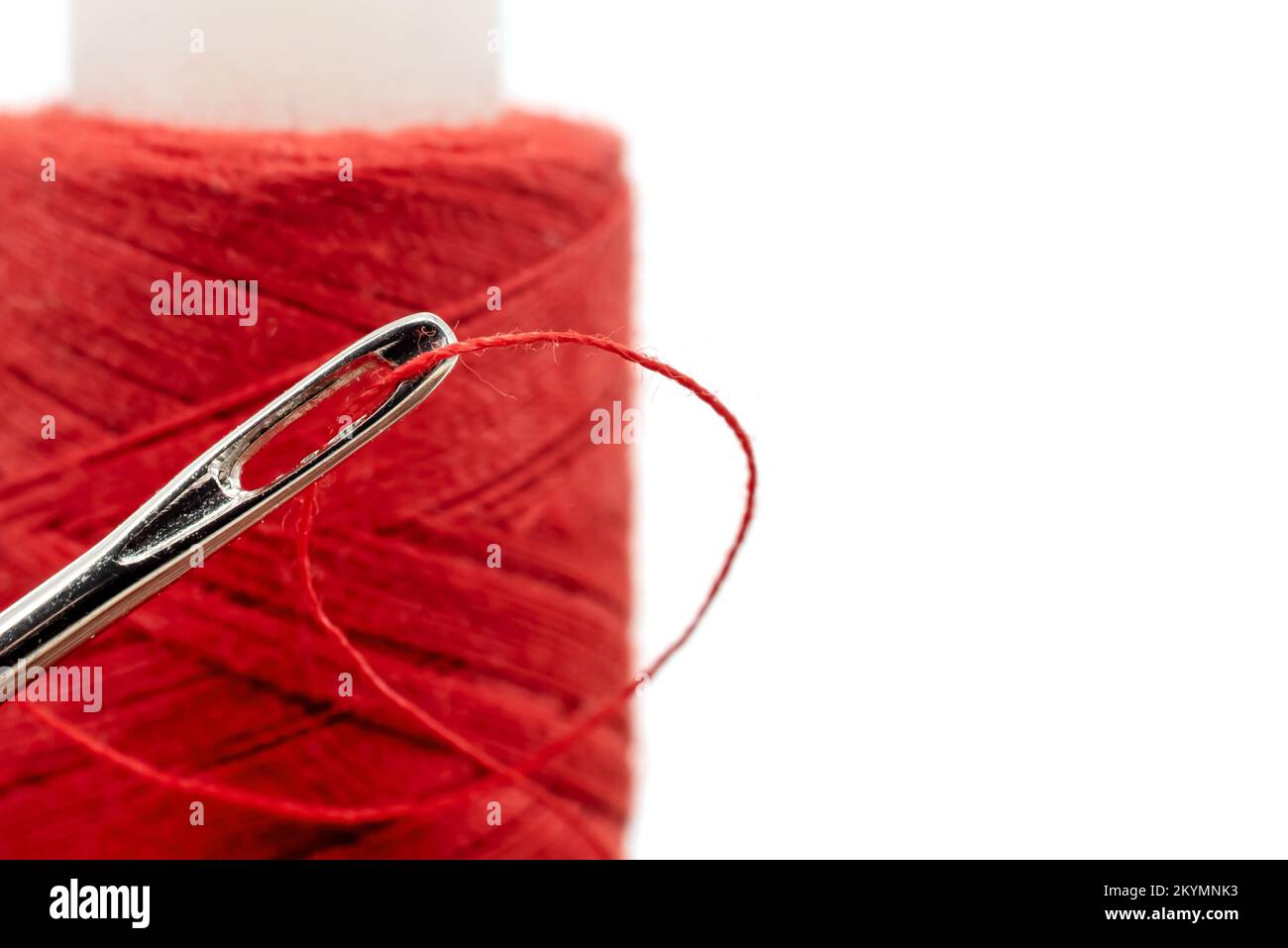 Needle with multi-colored threads on a white background. Eye of a ...