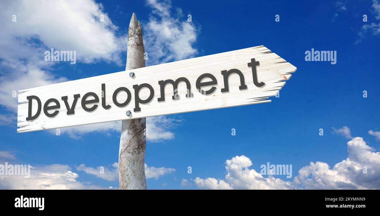 Development - wooden signpost with one arrow Stock Photo - Alamy