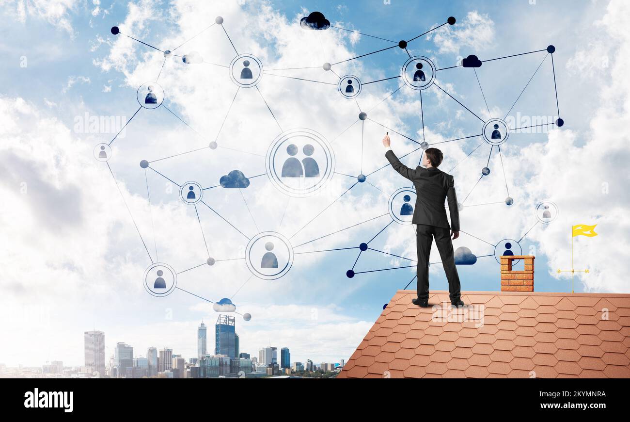 Businessman on house roof presenting networking and connection concept ...