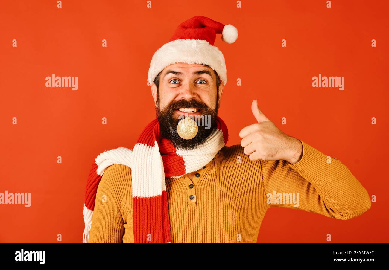 Santa shows thumbs up. Santa Claus holds golden ball Stock Photo - Alamy