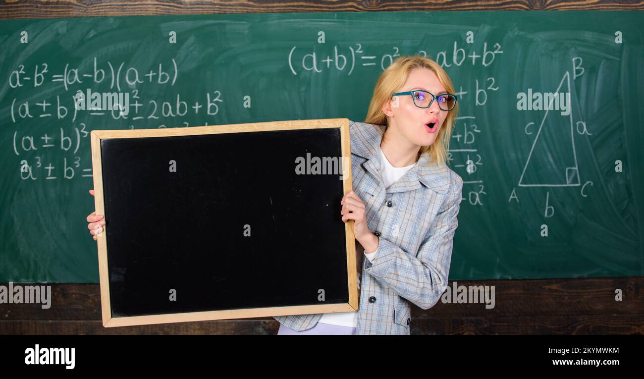 School schedule and extra classes. Teacher woman hold blackboard blank ...