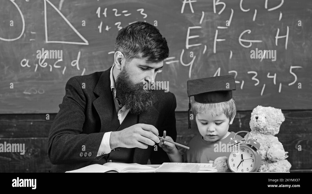Mathematics lesson concept. Father teaches son mathematics. Teacher in ... Mathematics lesson concept. Father teaches son mathematics. Teacher in ...