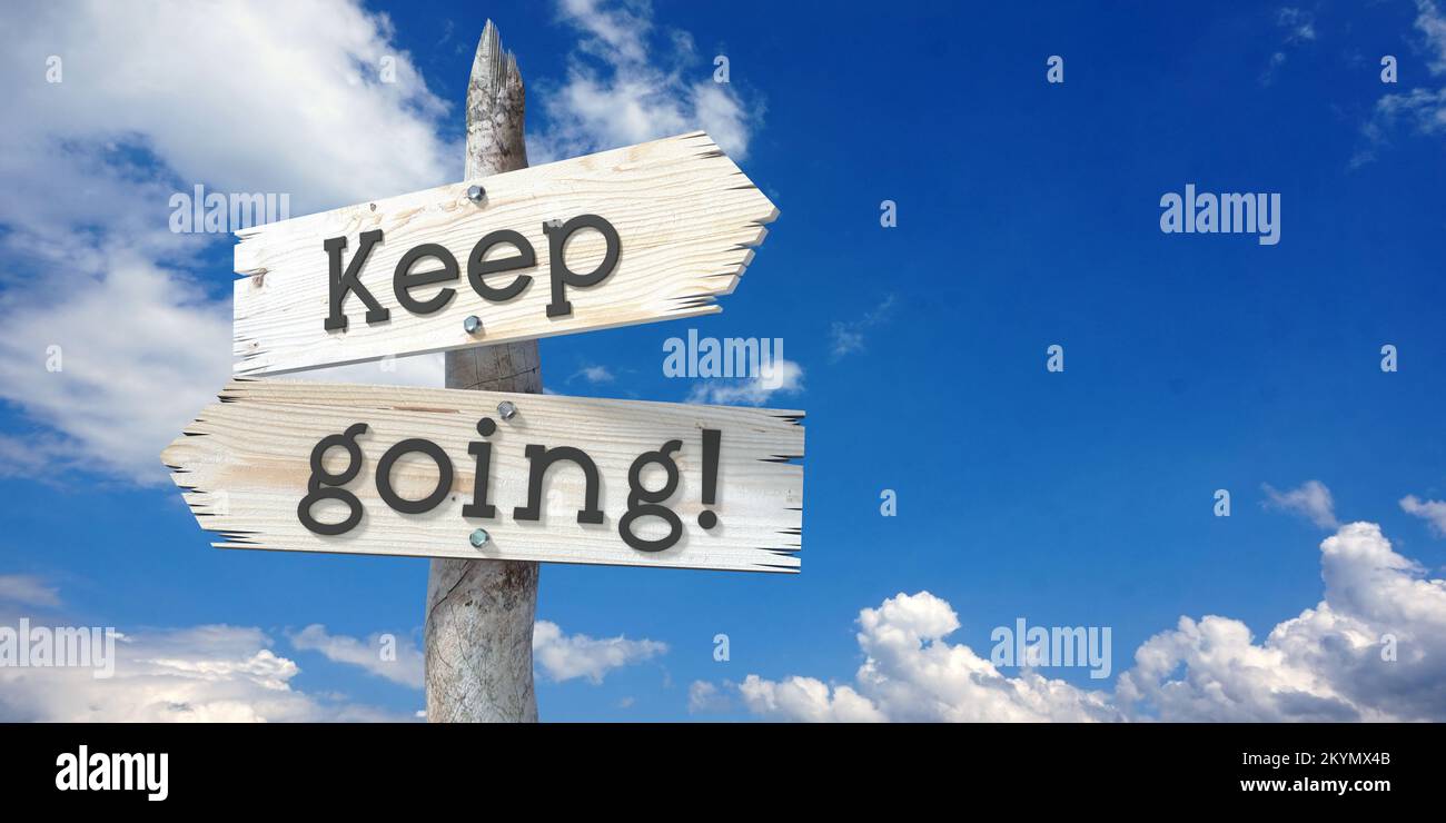 Keep going - wooden signpost with two arrows Stock Photo - Alamy