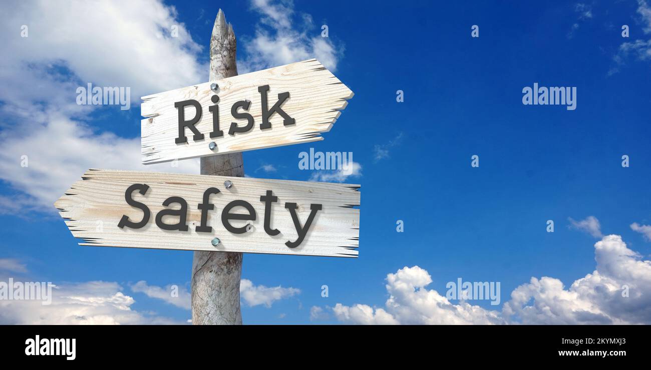 Risk, safety - wooden signpost with two arrows Stock Photo - Alamy