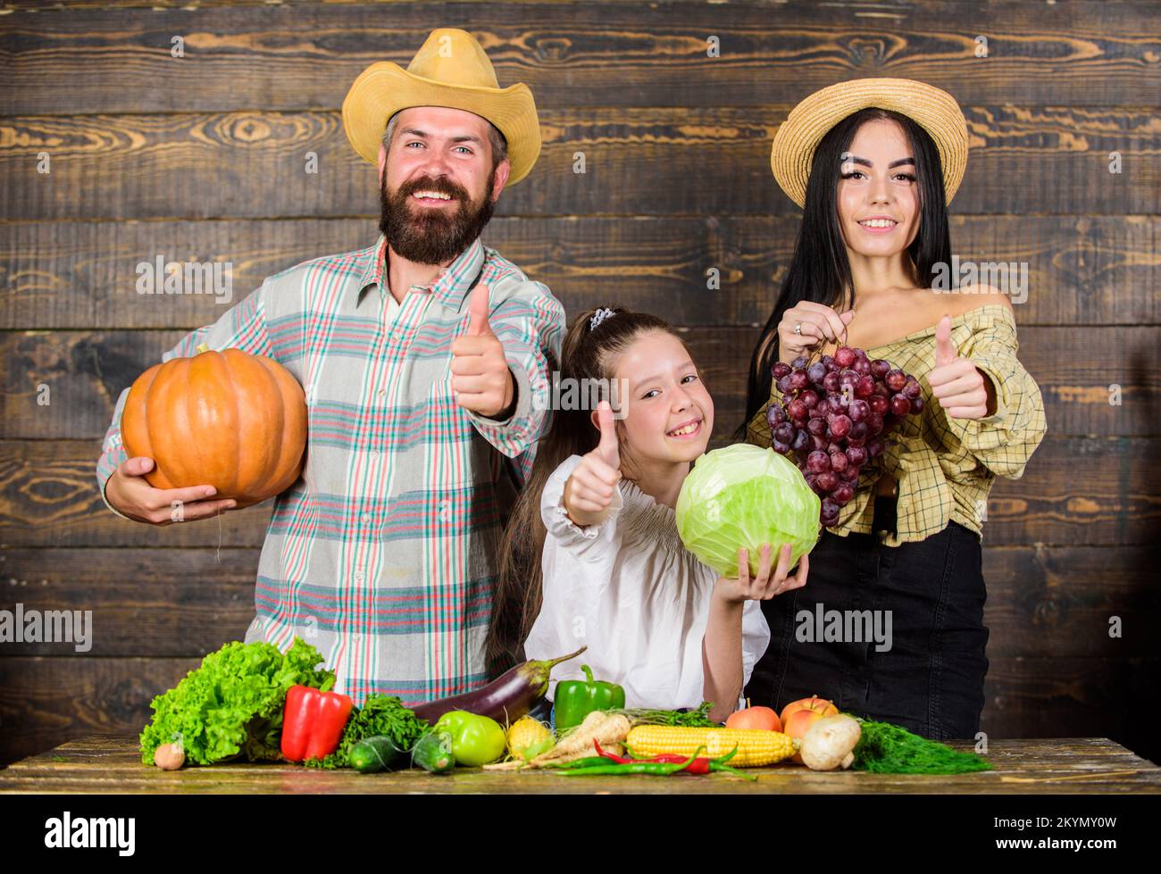 Harvest festival concept. Family farmers with harvest wooden background ...