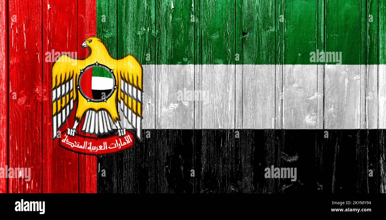 Flag and coat of arms of the United Arab Emirates on a textured ...