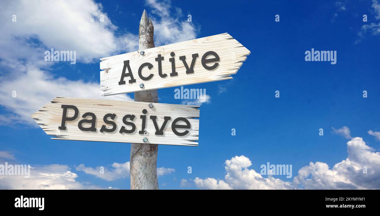 Active, passive - wooden signpost with two arrows Stock Photo - Alamy
