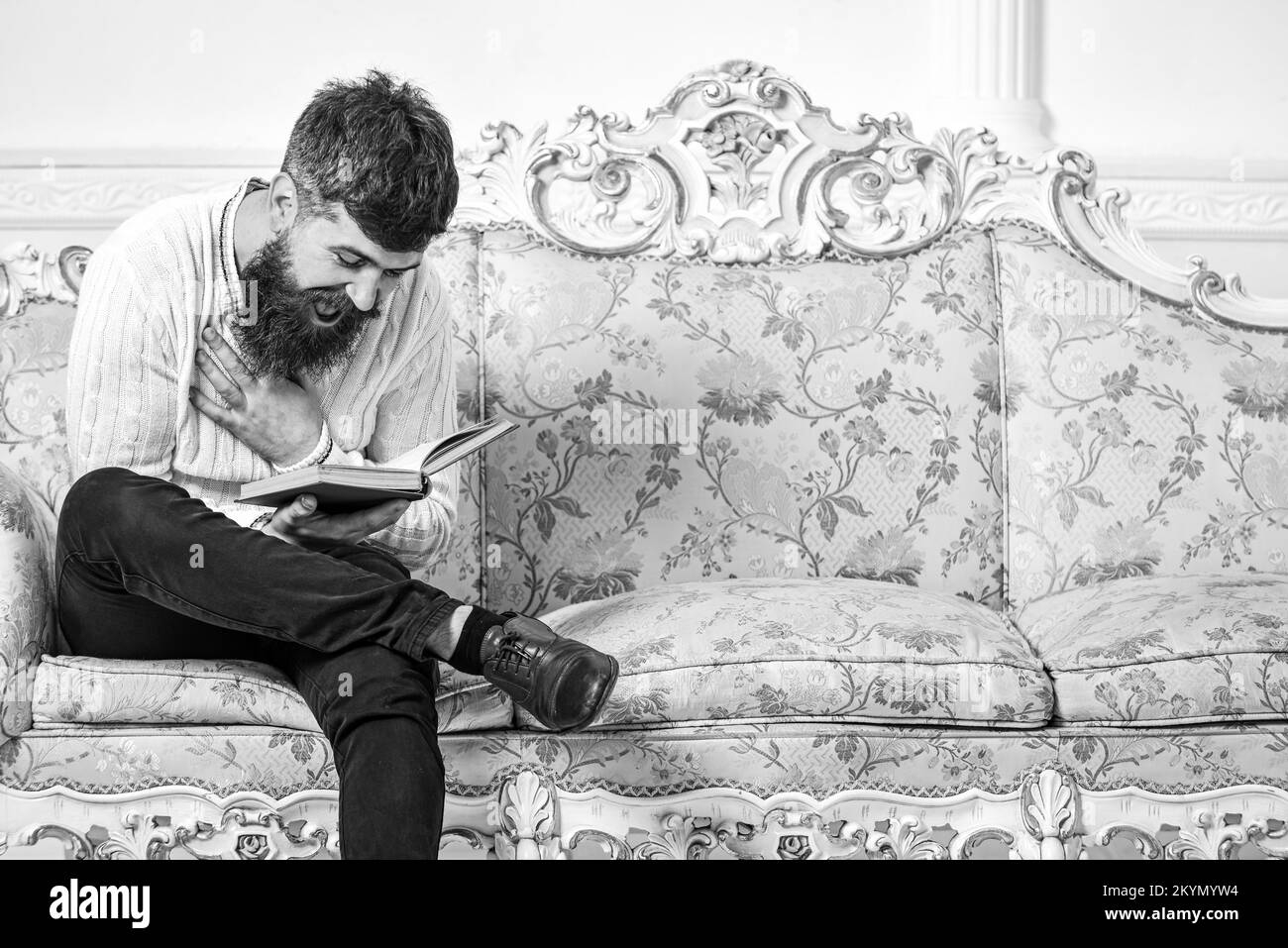 Guy reading old book with enjoyment. Humorous literature concept. Macho ...