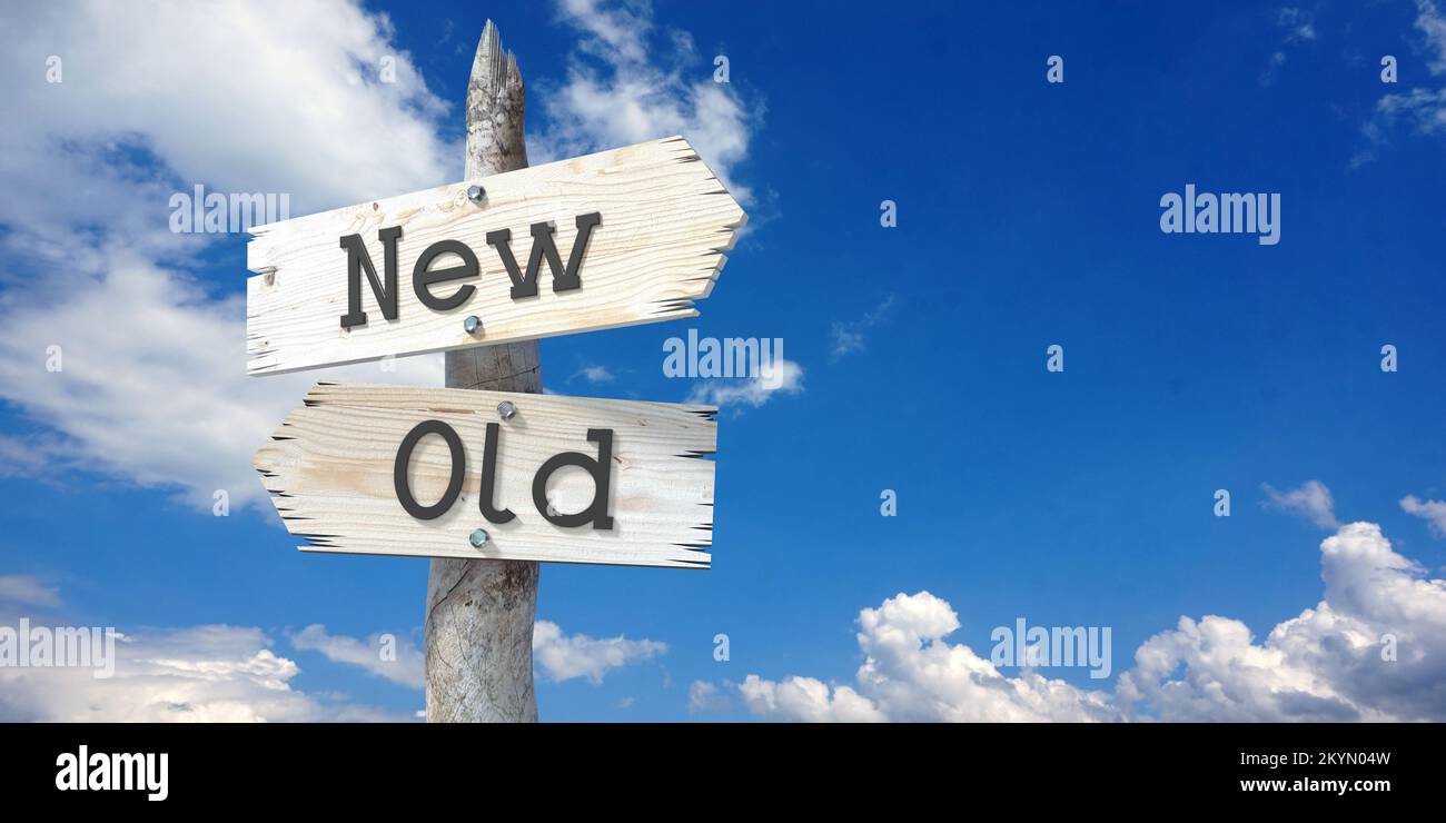 Old and new - wooden signpost with two arrows Stock Photo - Alamy