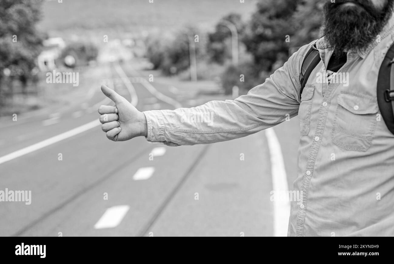 Autostop travel. Pick me up. Thumb up gesture try stop car road ...