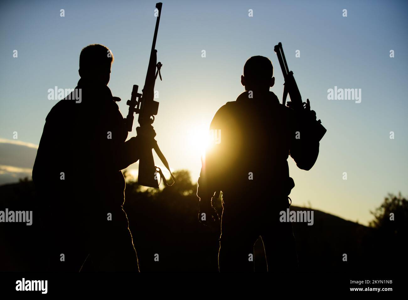 Hunters friends gamekeepers with guns silhouette sky background ...