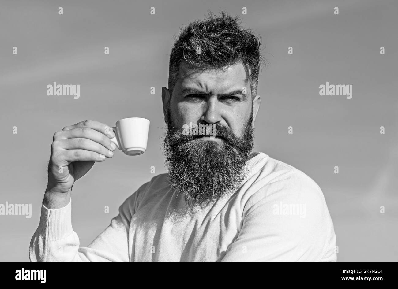 Bearded man with espresso mug, drinks coffee. Man with beard and ...