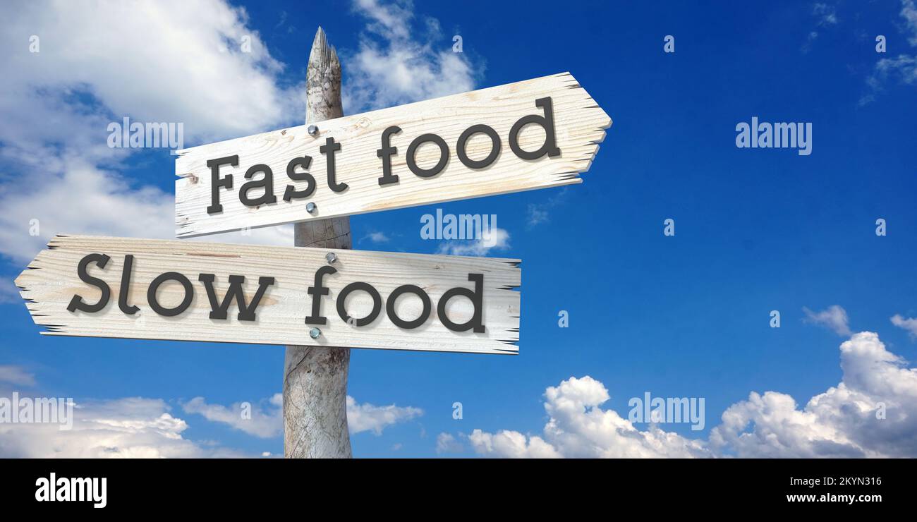 Slow food and fast food - wooden signpost with two arrows Stock Photo ...