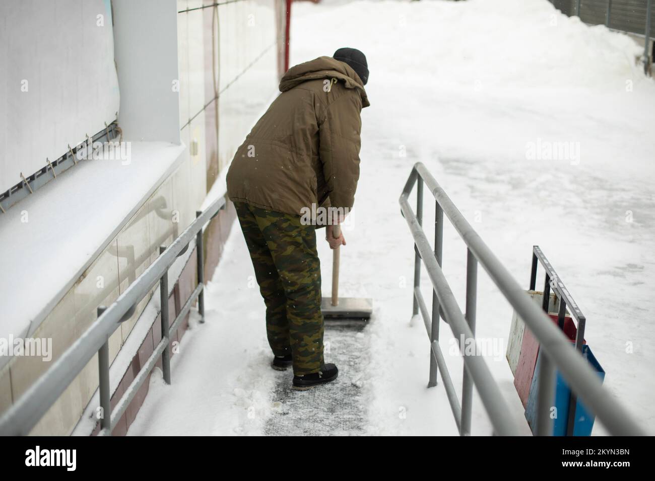 Snow removal. Man with shovel for snow removal. Work in yard in winter ...