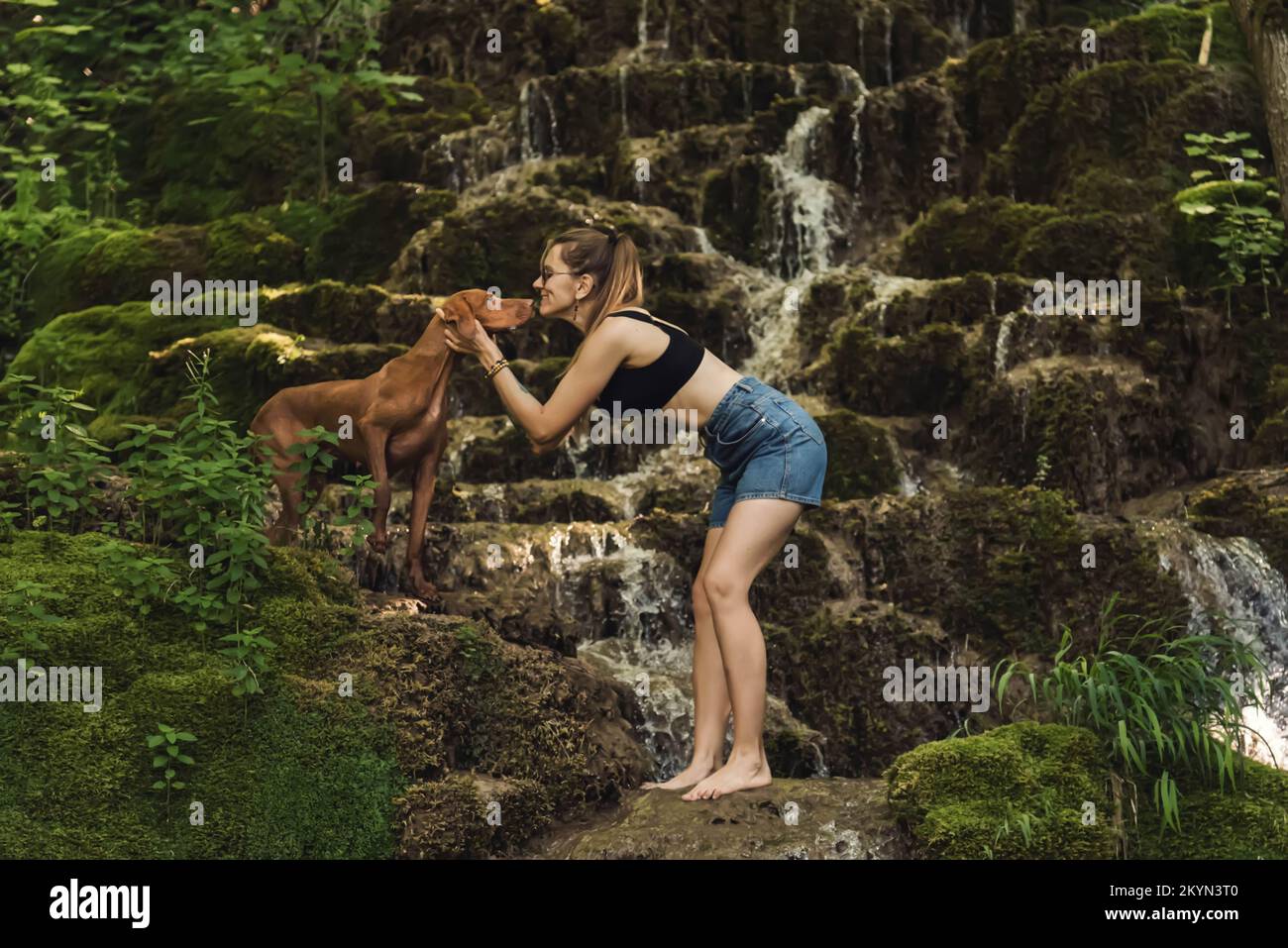 Woman with Dog in Nature by Mountain River Waterfall Stock Photo - Alamy