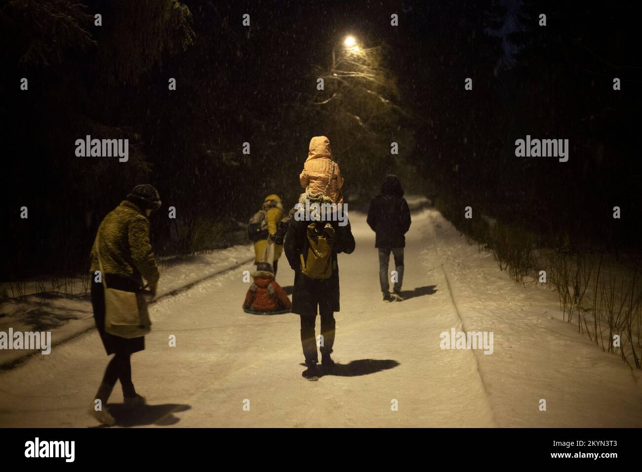 People go to park in evening. Winter walk. Road in snow Stock Photo - Alamy
