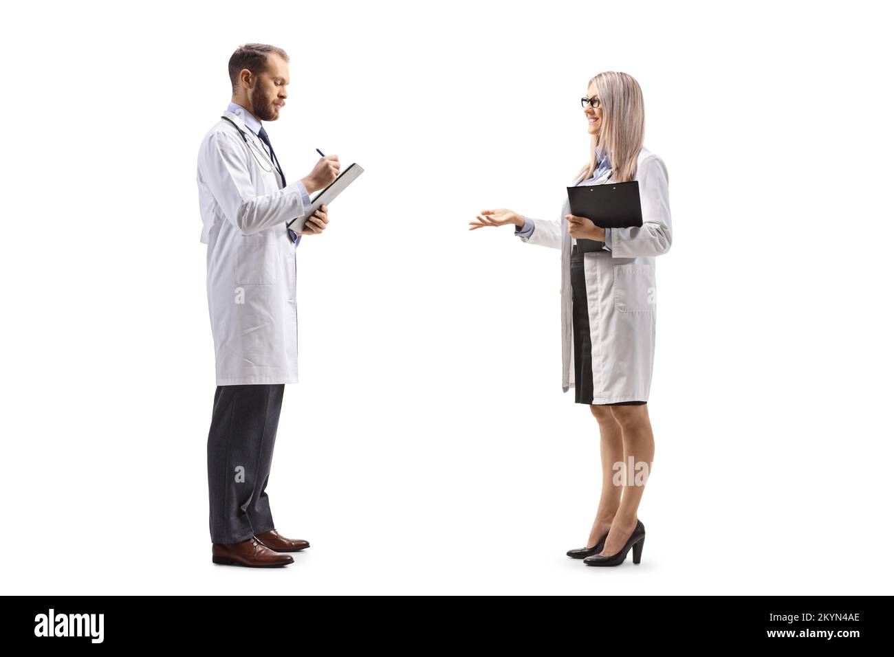 Full length profile shot of a male and female doctor standing and ...