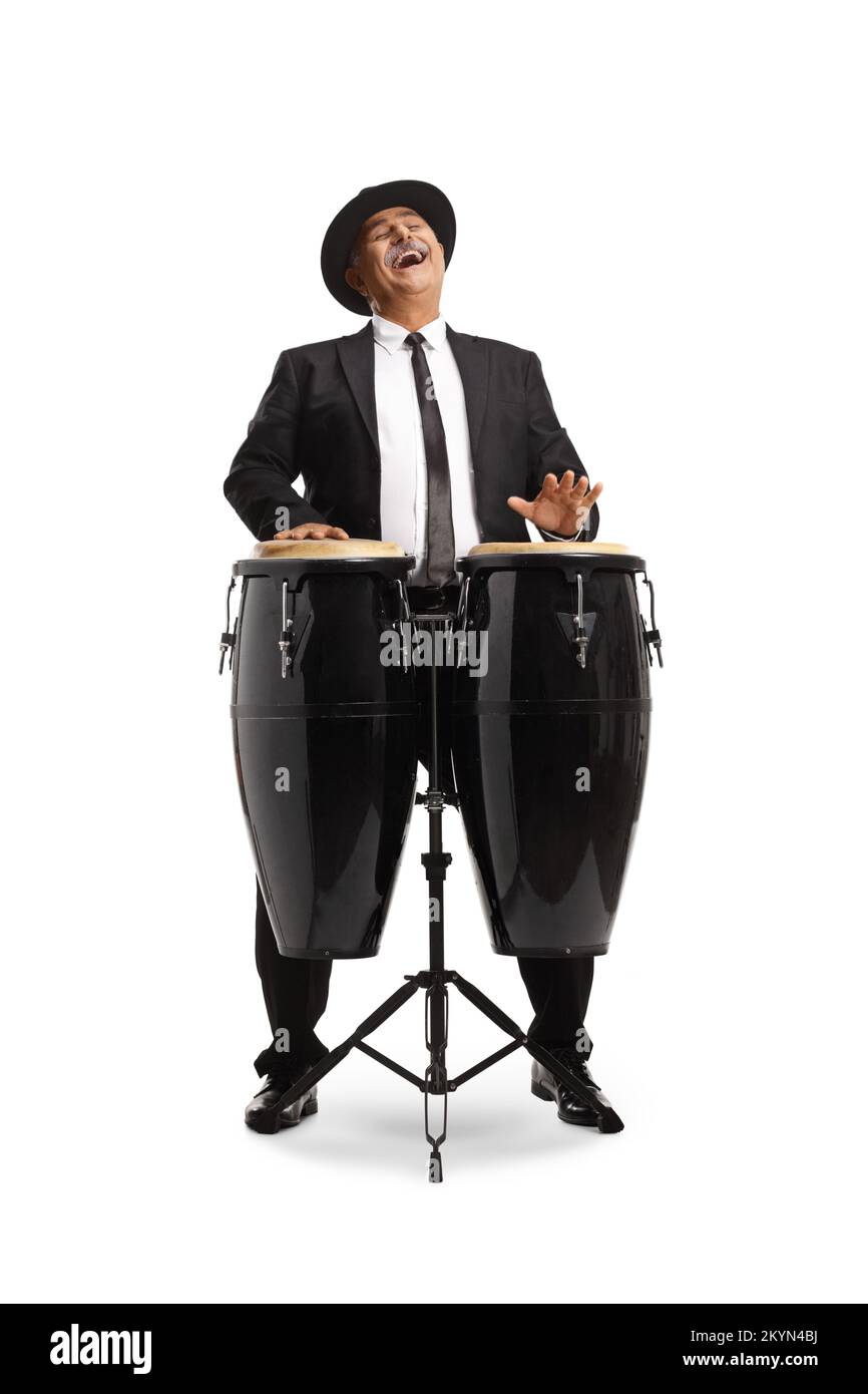 Cheerful mature man playing conga drums and singing isolated on white ...