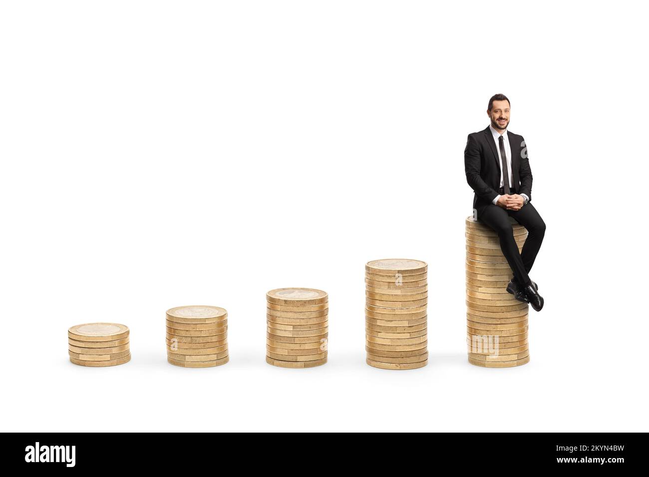 Rising piles of coins and businessman sitting on top isolated on white ...