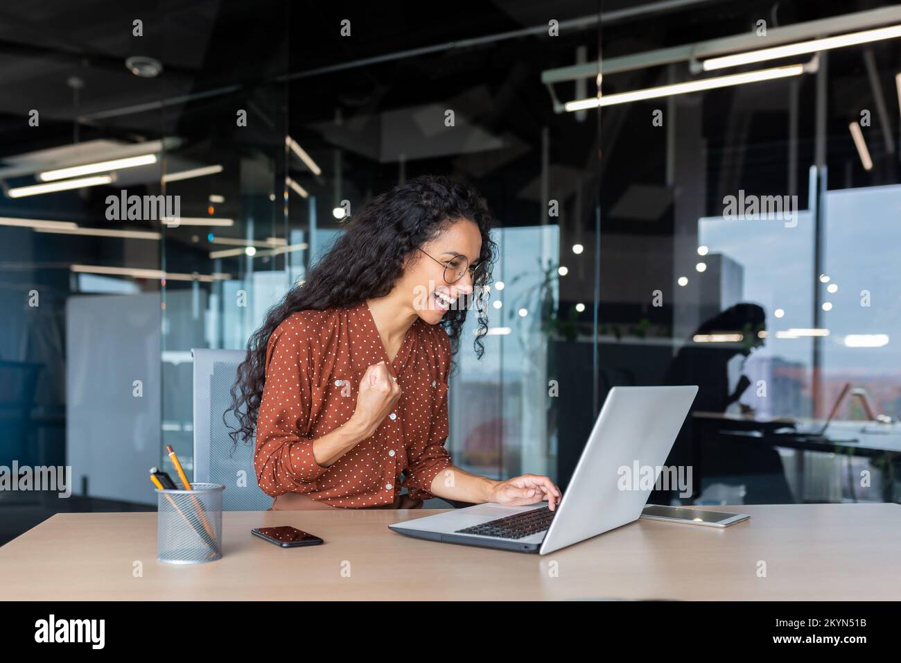 Hispanic businesswoman celebrating victory and successful achievement ...