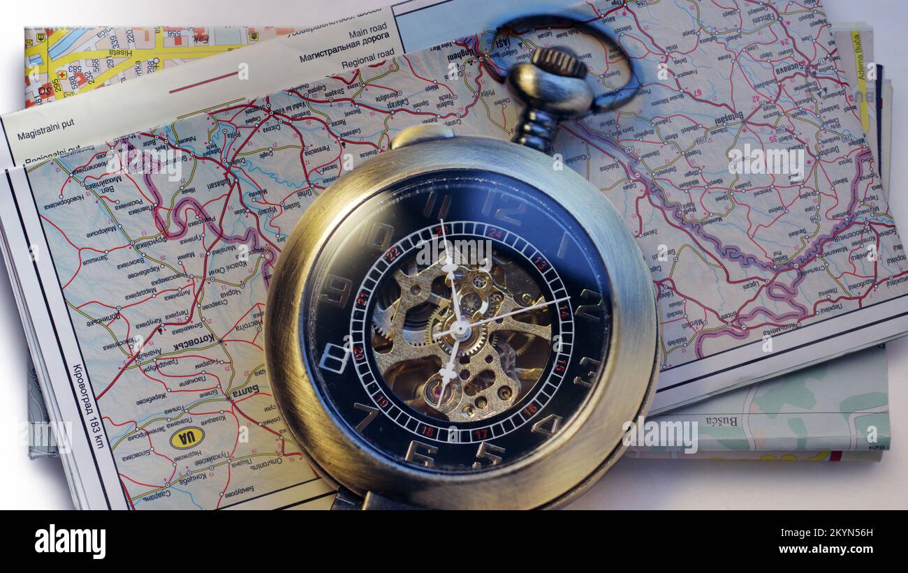 Pocket watch with two road maps Stock Photo - Alamy