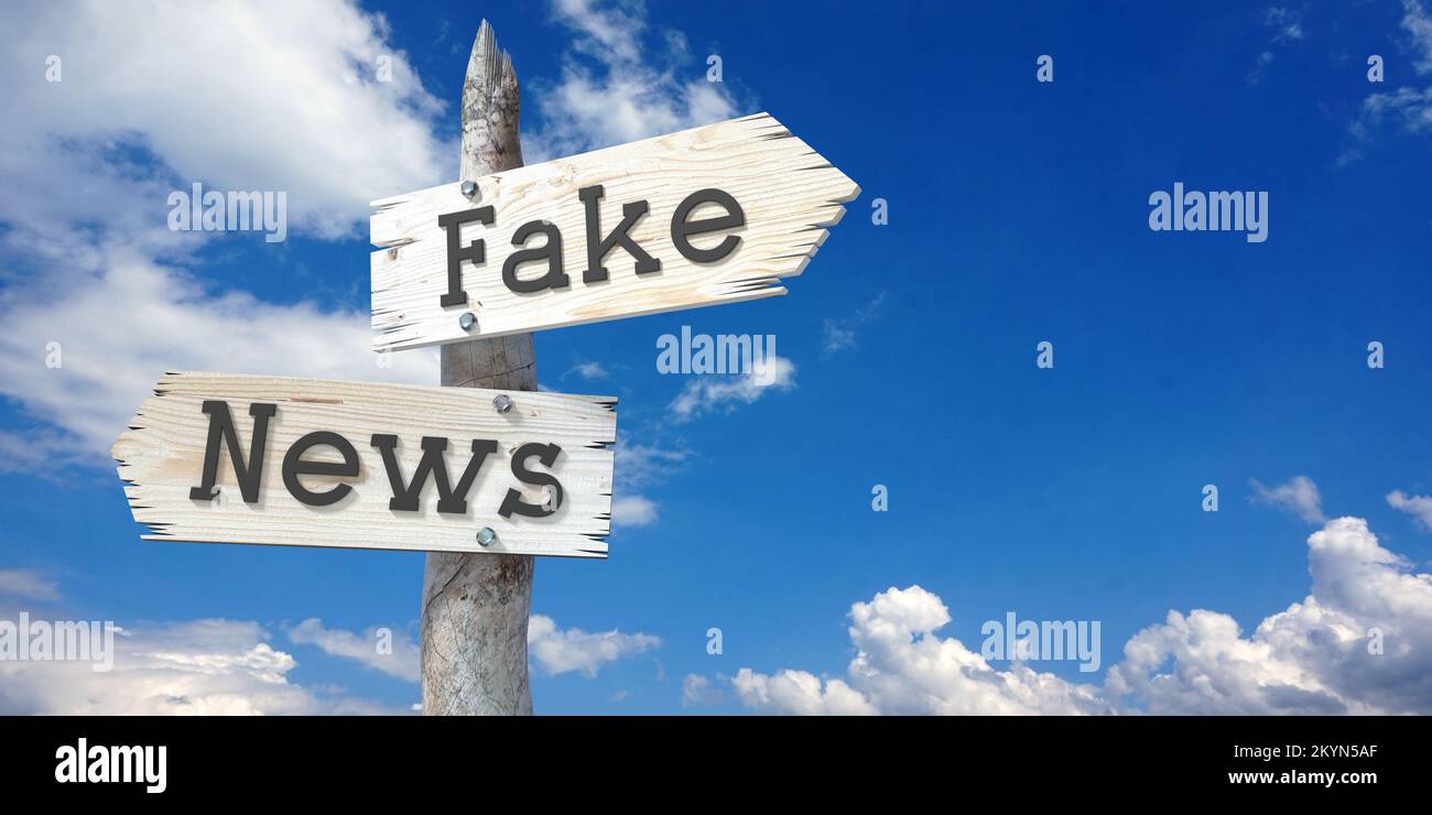 Fake news - wooden signpost with two arrows Stock Photo - Alamy
