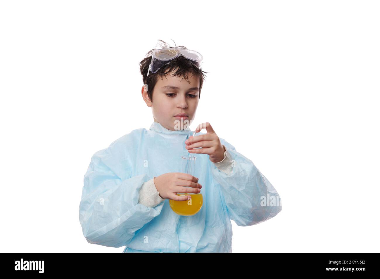 Smart teenage schoolboy conducting experiment, using a glass stick ...